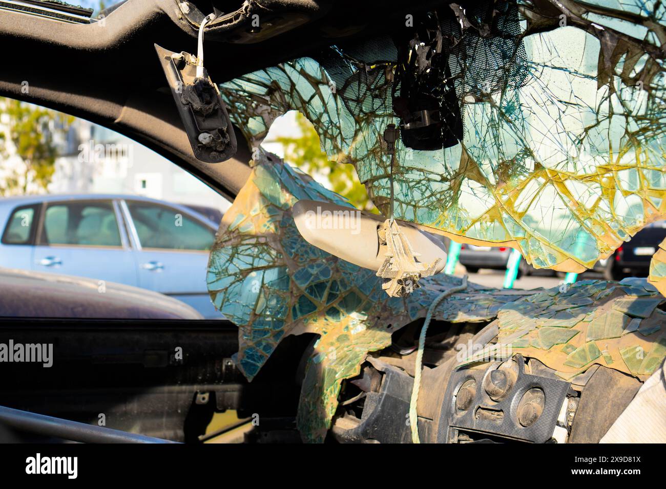 An abandoned car with a broken windshield, showing signs of damage and ...