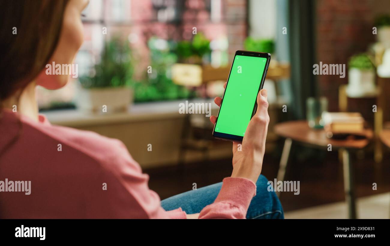 Feminine Hand Holding a Smartphone with Green Screen Mock Up Display ...