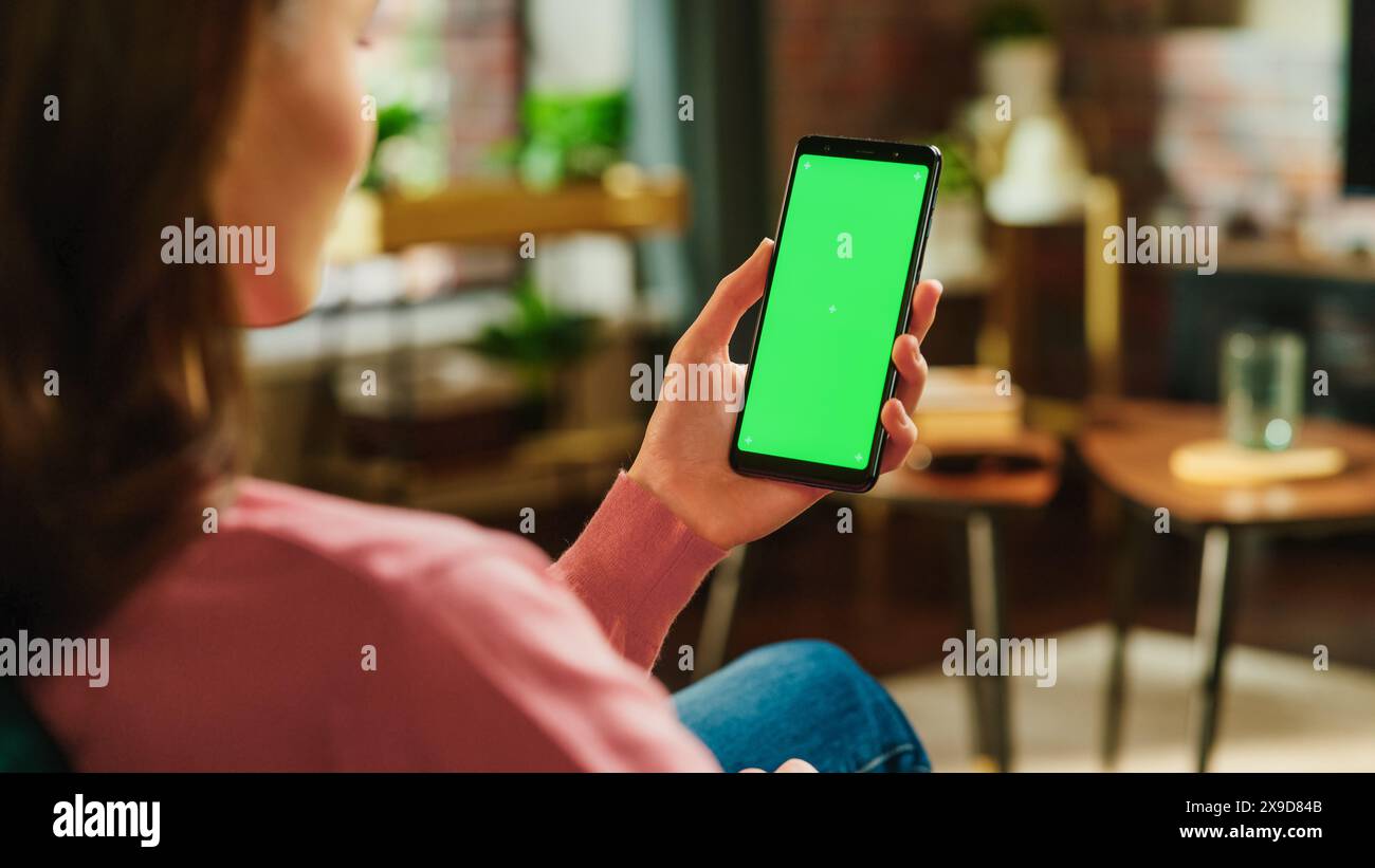 Feminine Hand Tapping on Display and Scrolling Feed on Smartphone with Green Screen Mock Up ...