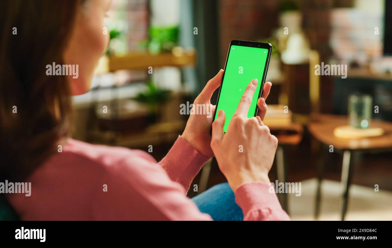 Feminine Hand Tapping on Display and Scrolling Feed on Smartphone with Green Screen Mock Up ...