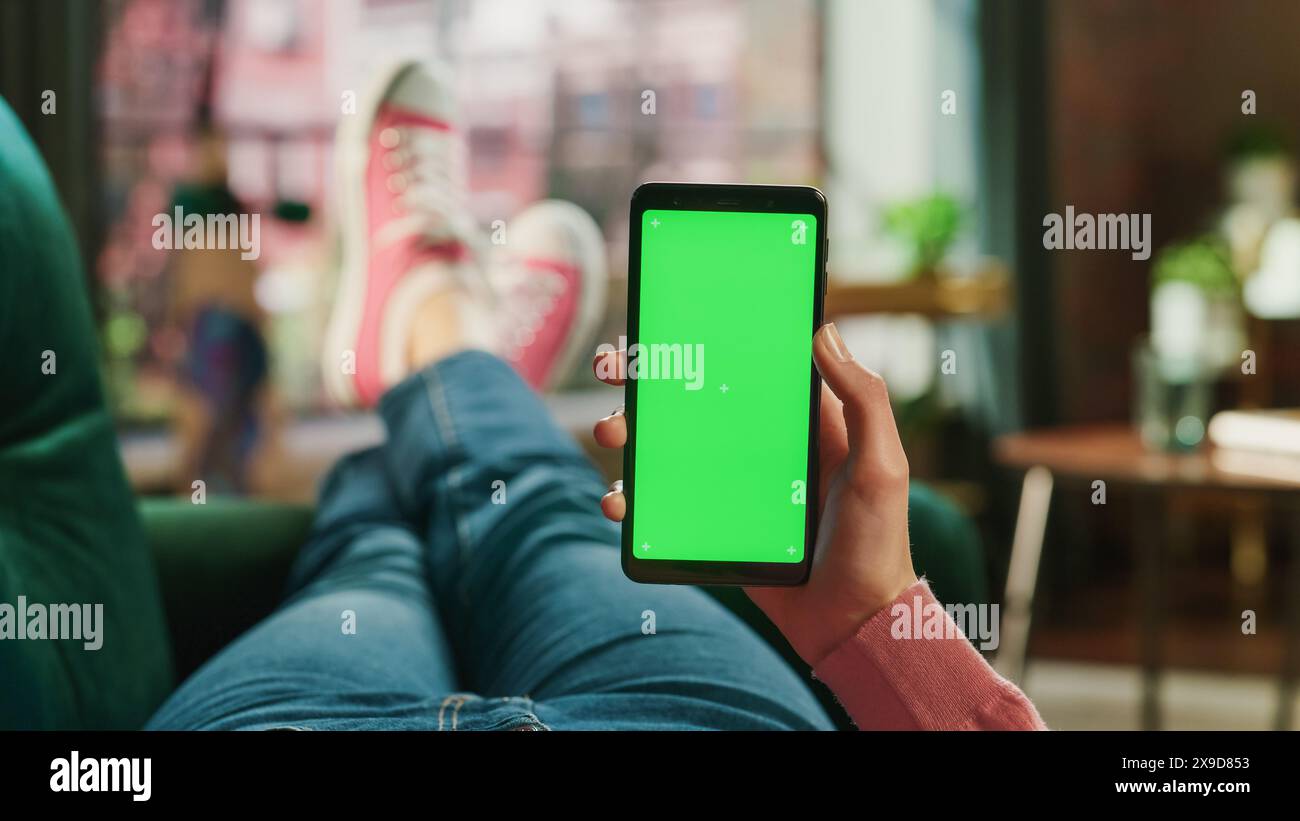 Feminine Hand Holding a Smartphone with Green Screen Mock Up Display ...