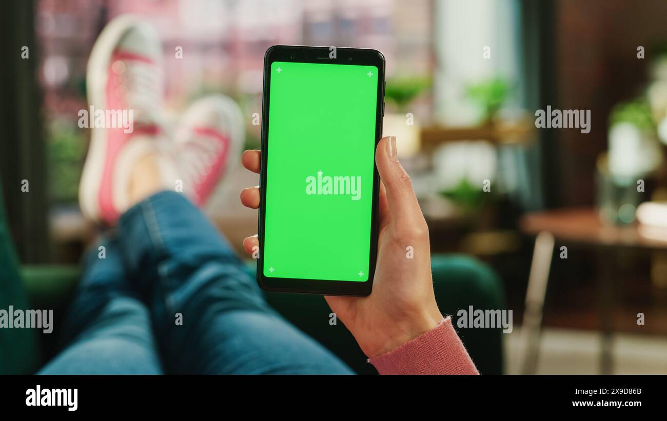 Feminine Hand Holding a Smartphone with Green Screen Mock Up Display ...