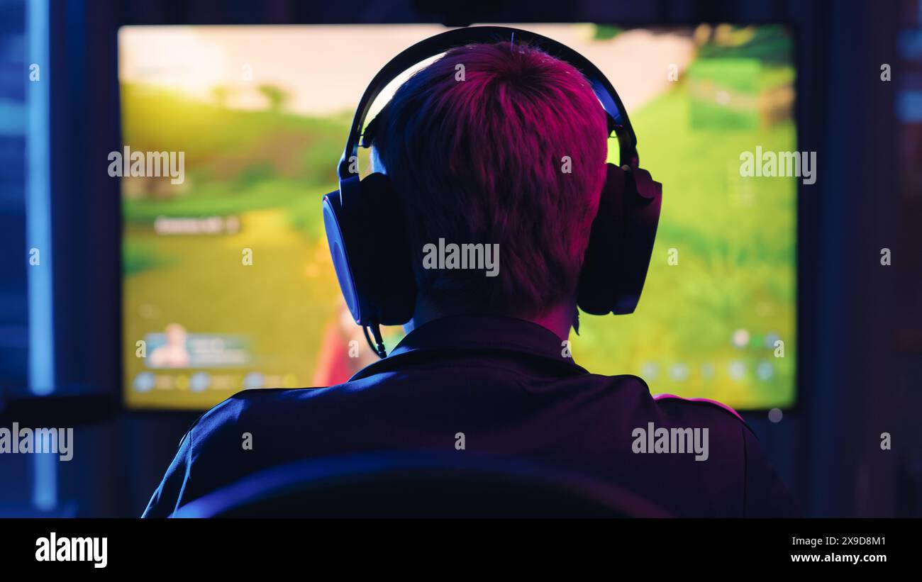 Back of the Head Angle of a Young Female Gamer Wearing Headset and ...