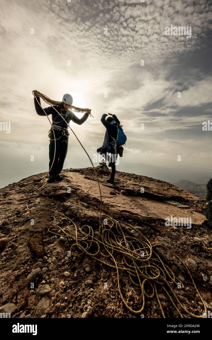 climbers at the top of the mountain in montserrat with ropes ...