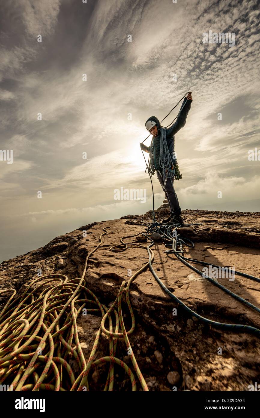 climbers at the top of the mountain in montserrat with ropes ...