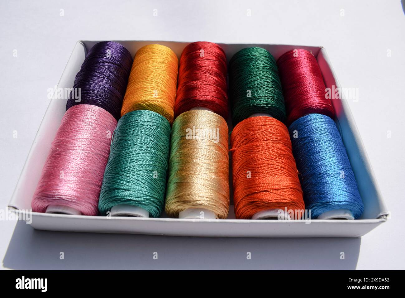 Different colors of Silk thread rolls used for embroidery work and ...