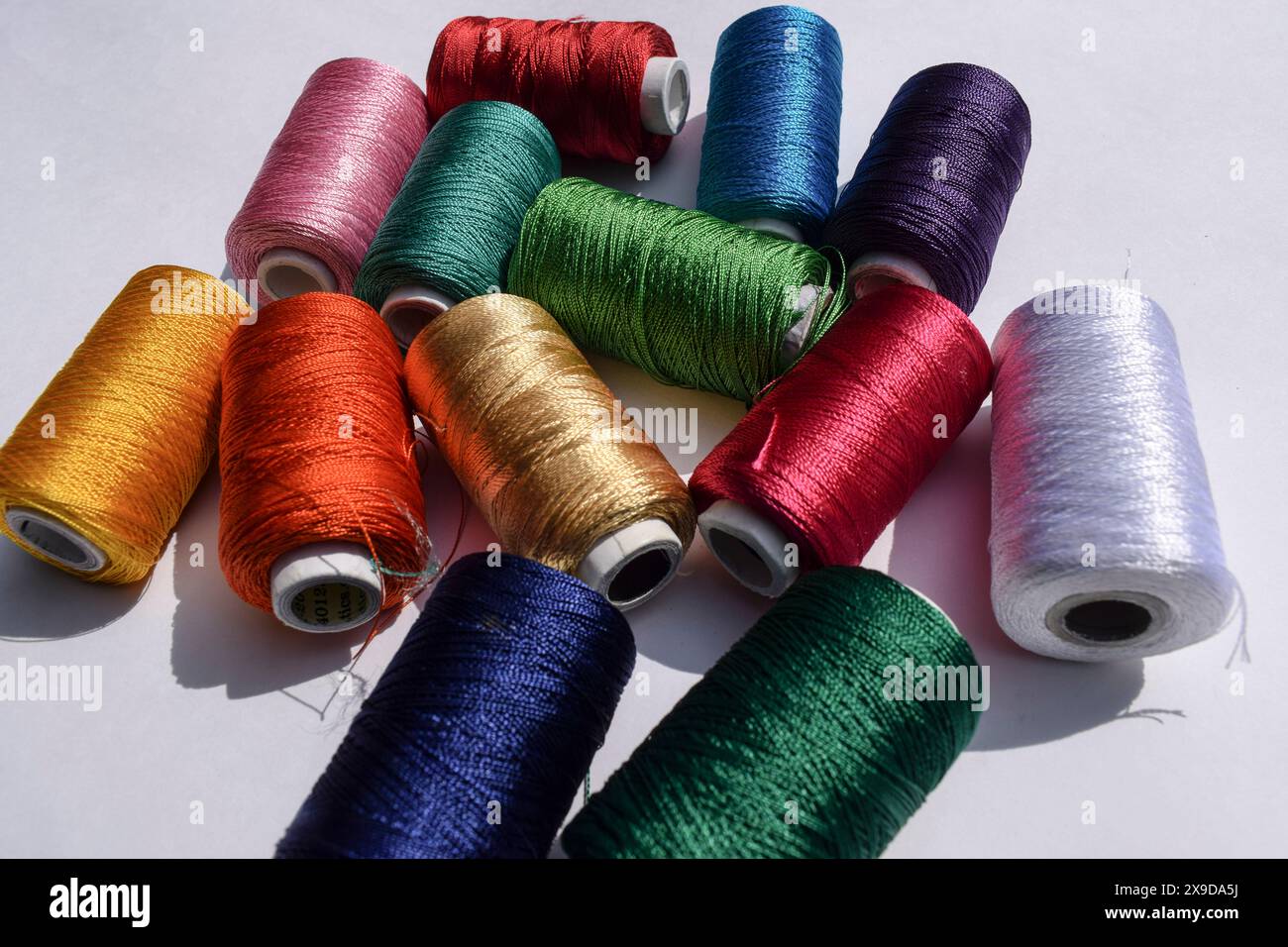 Different colors of Silk thread rolls used for embroidery work and ...