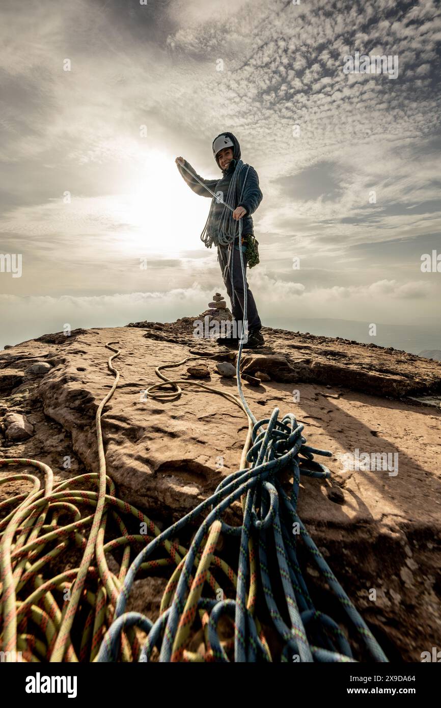 climbers at the top of the mountain in montserrat with ropes ...