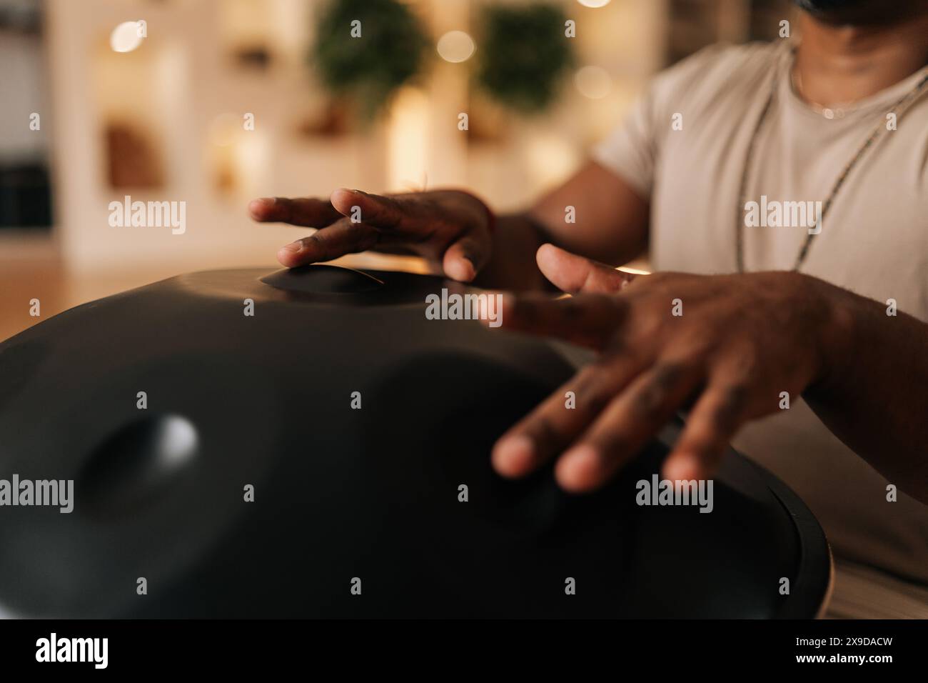 Closeup black male hands playing tongue drum musical instrument, metal ...