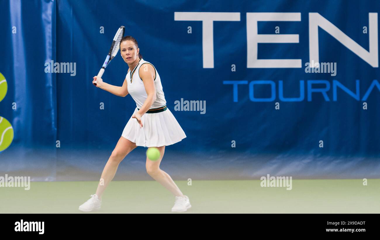 Female Tennis Player Hitting Ball with a Racquet During Championship ...