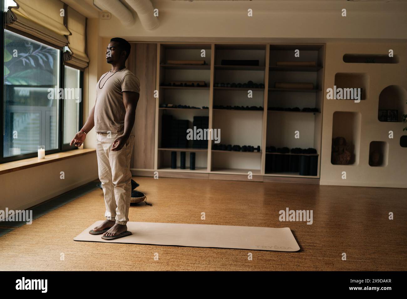 Full length portrait of meditated African-American man deep breathing ...