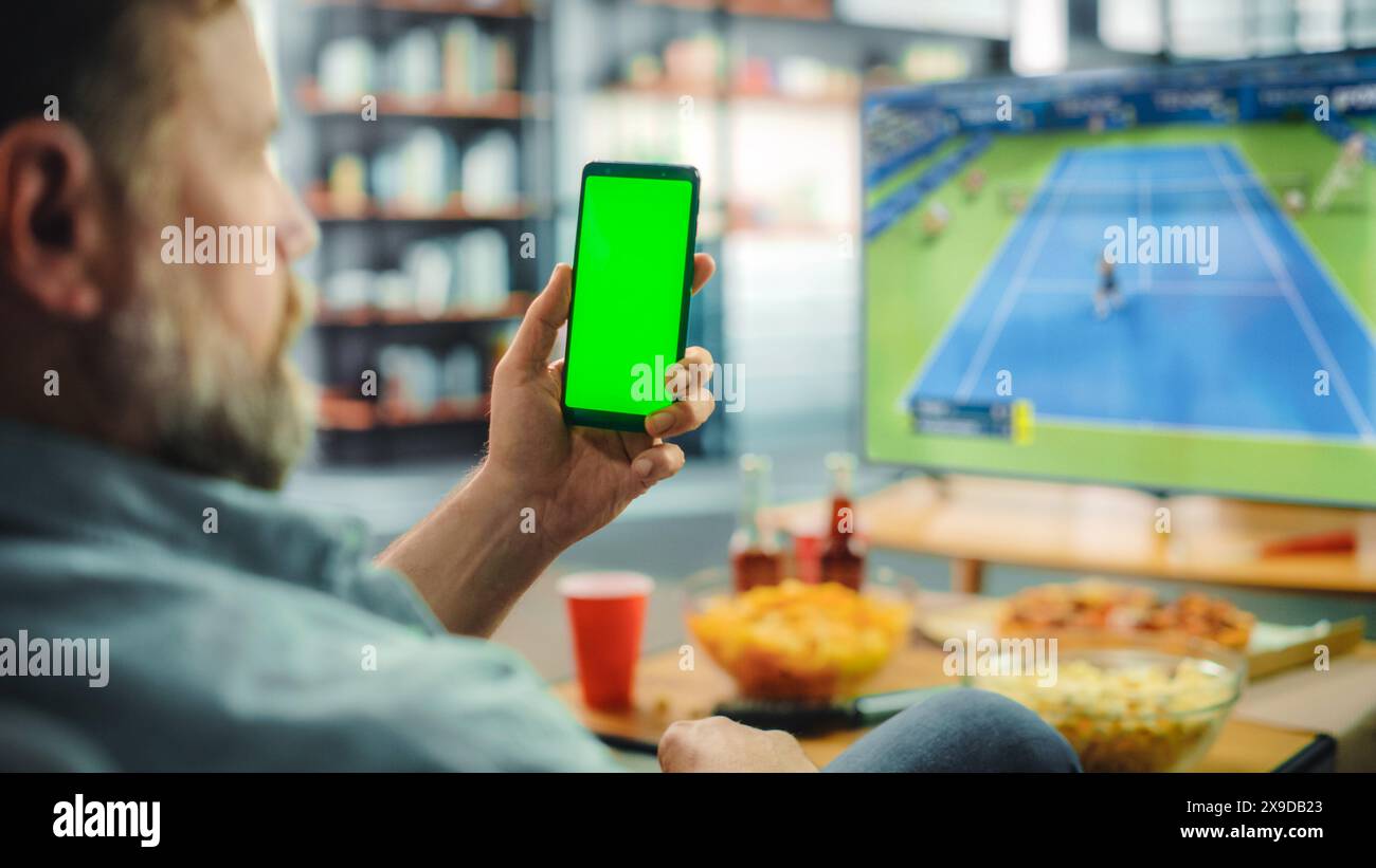 At Home Tennis Fan Holds Green Screen Chroma Key Smartphone, Friends ...