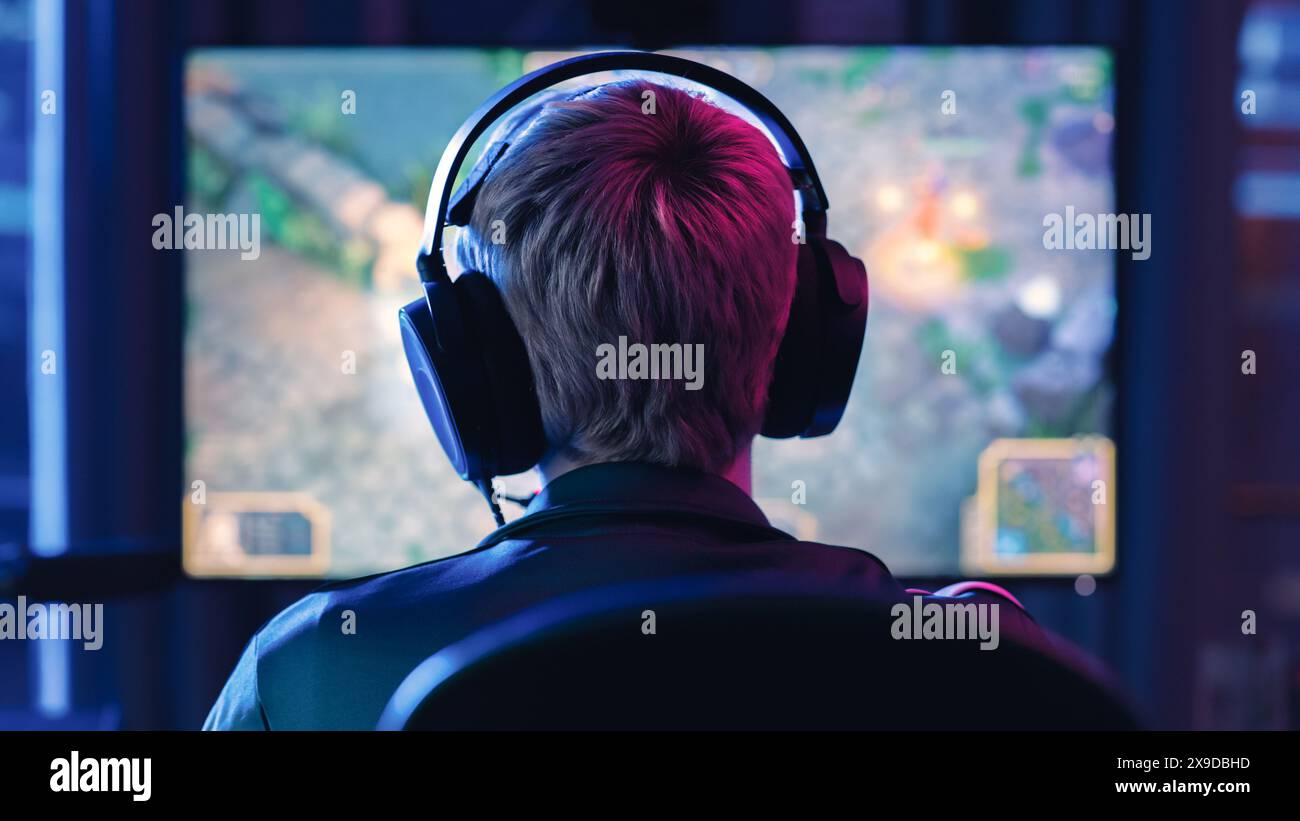 Back of the Head Angle of a Young Female Gamer Wearing Headset and ...