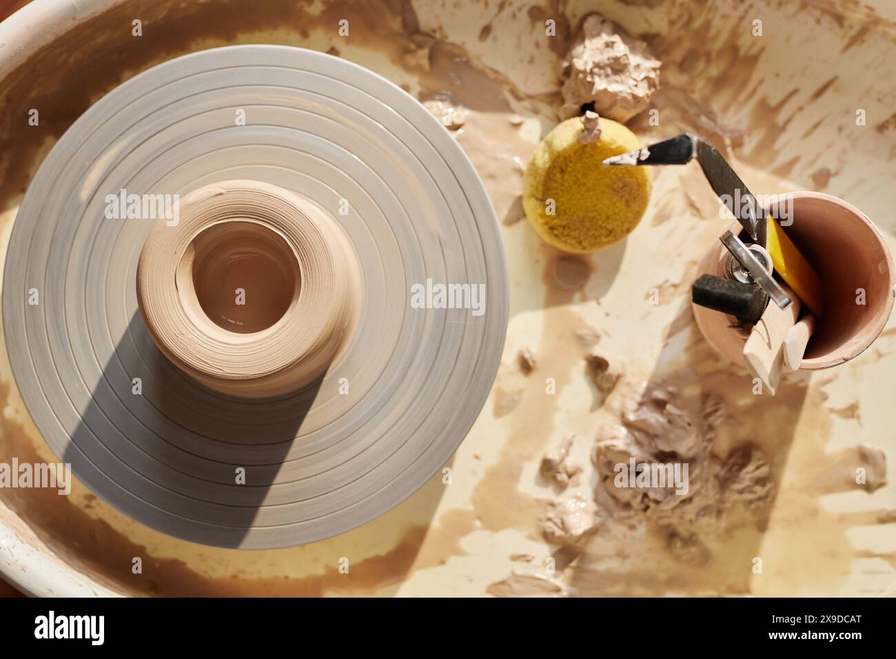 Top view background image of well-used pottery wheel in sunlight with ...