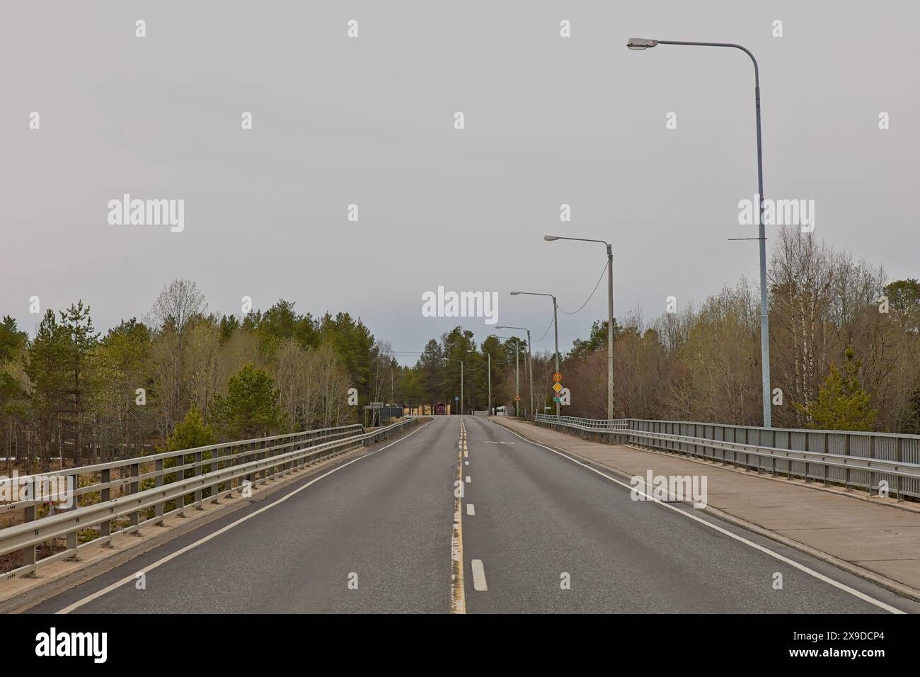 Bridge on E75 road over Vuotso canal in cloudy spring weather, Lapland ...