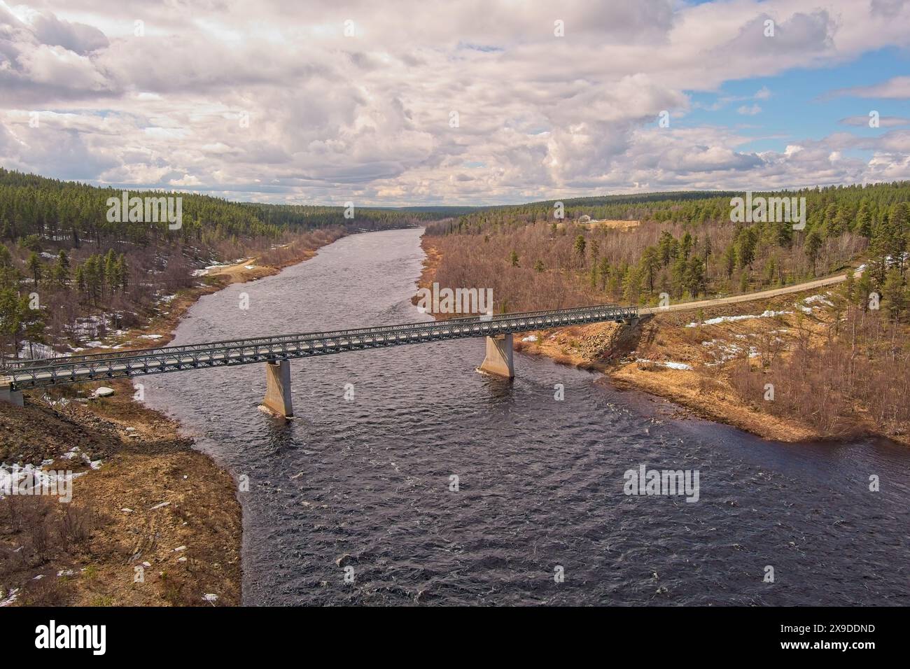 Aerial view of Kuttura bridge over Ivalojoki river in cloudy spring ...