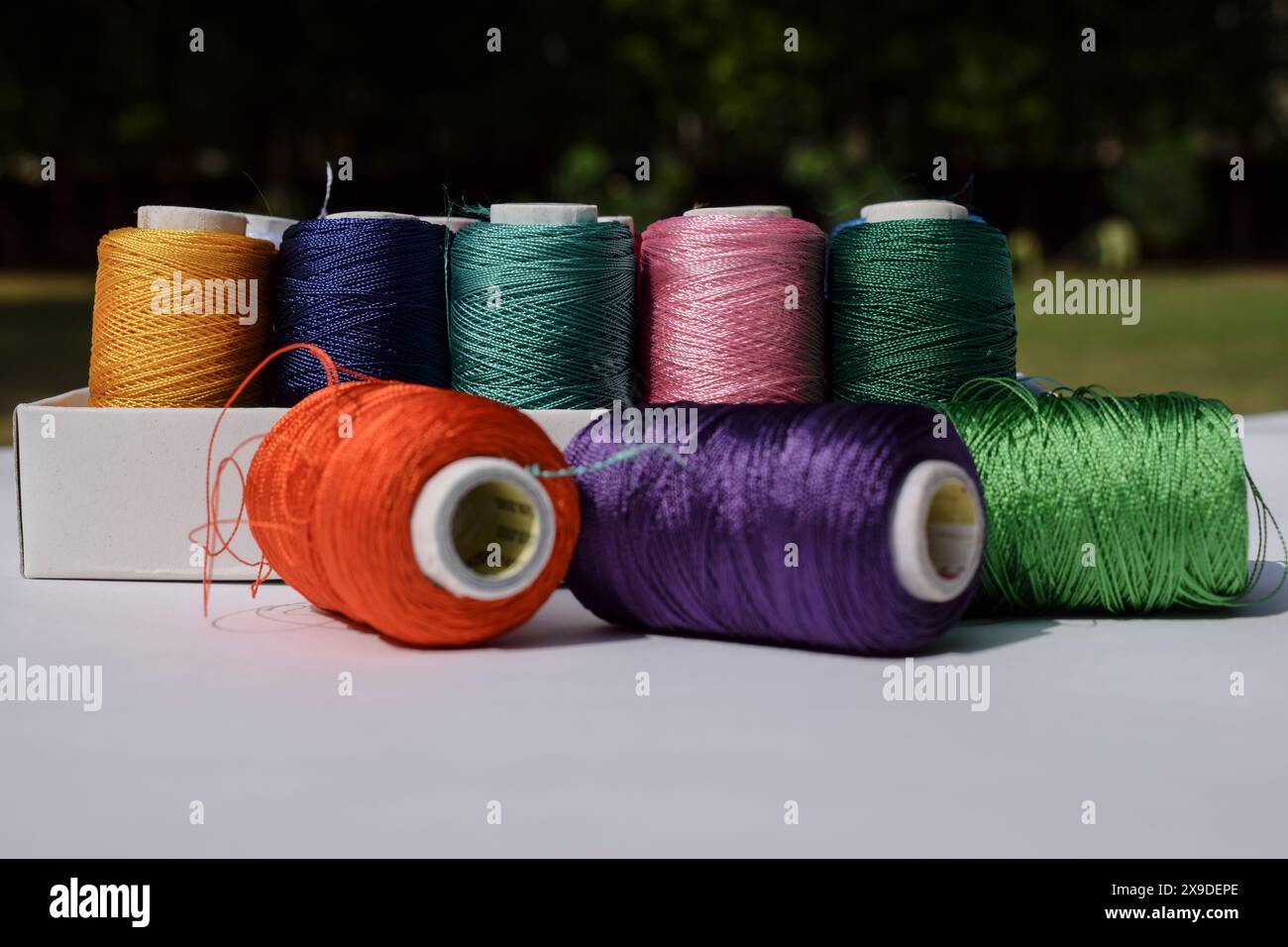 Different colors of Silk thread rolls used for embroidery work and ...