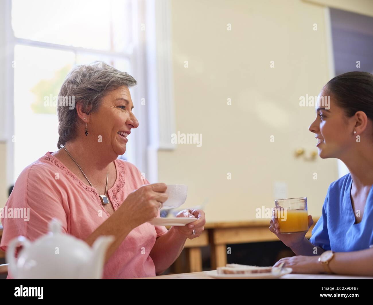Woman, conversation and caregiver of advice in nursing home for ...