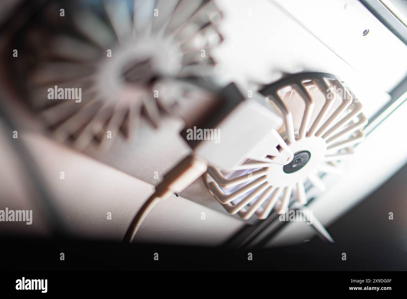 Close-up view of a USB fan connected to a device, with a blurred ...