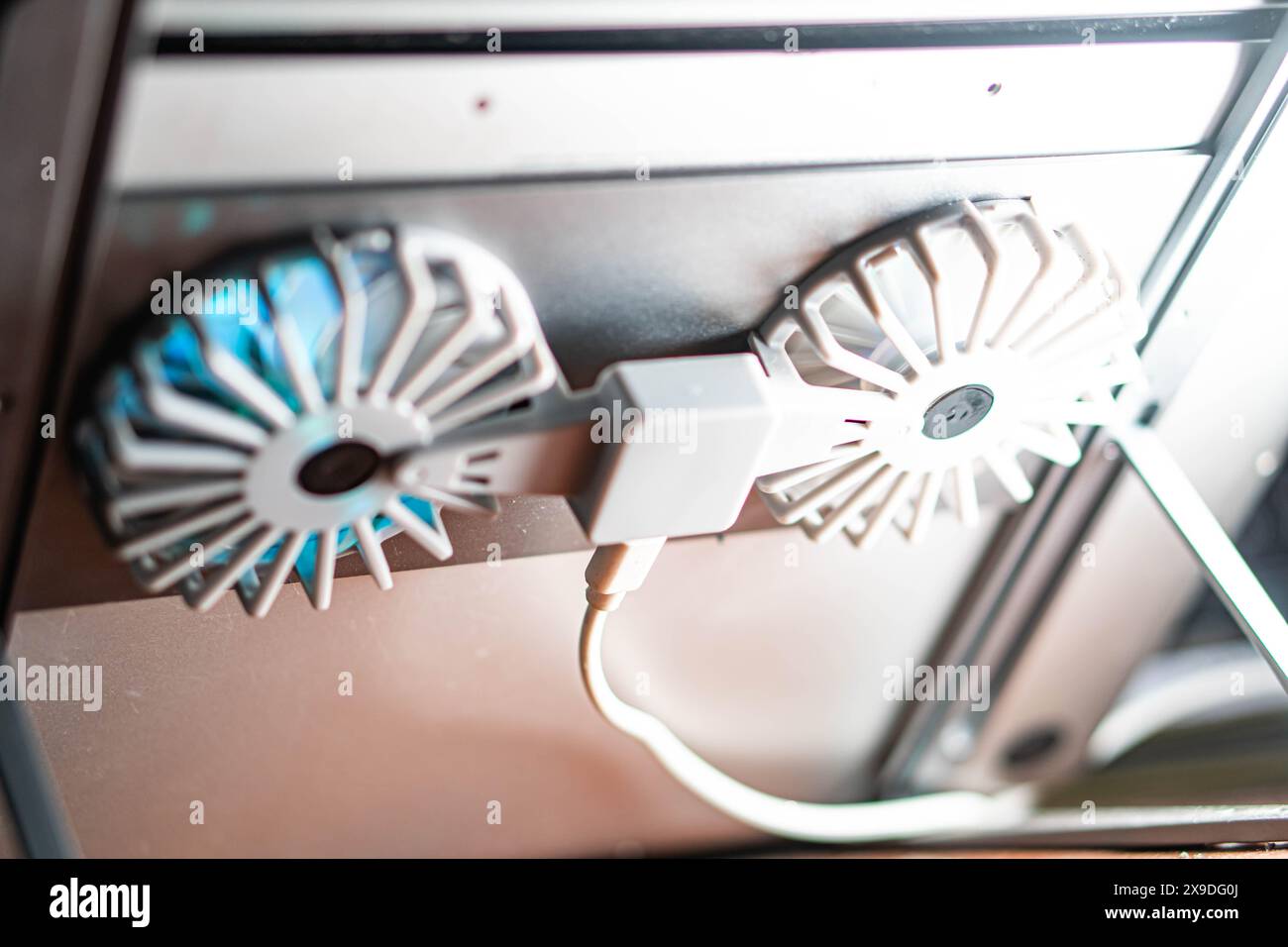 Close-up of a dual-fan cooling system attached to the underside of a ...