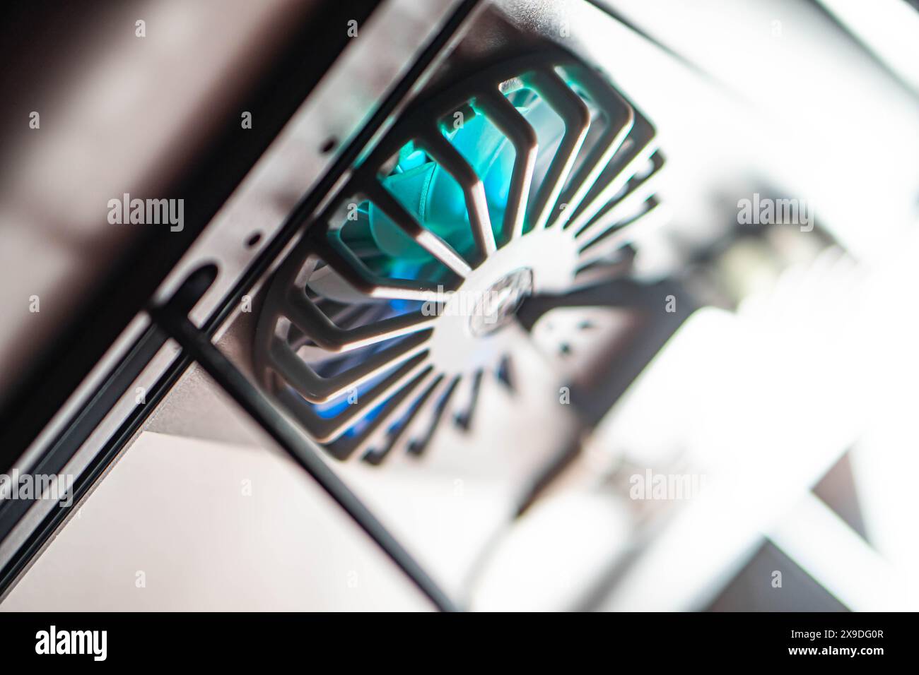 Close-up of a cooling fan inside a computer case with blue lighting ...