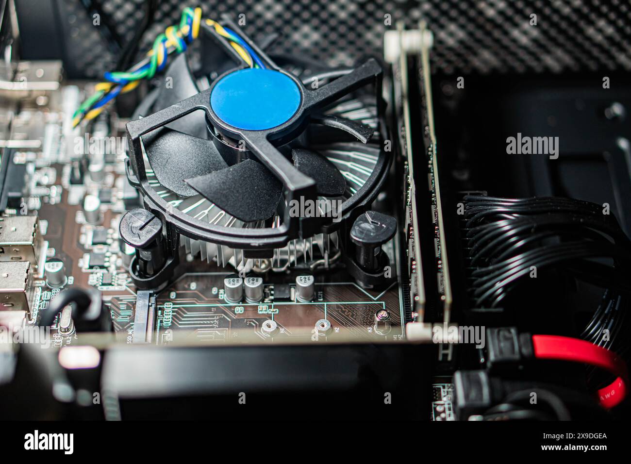Close-up view of a computer motherboard with a cooling fan and various ...