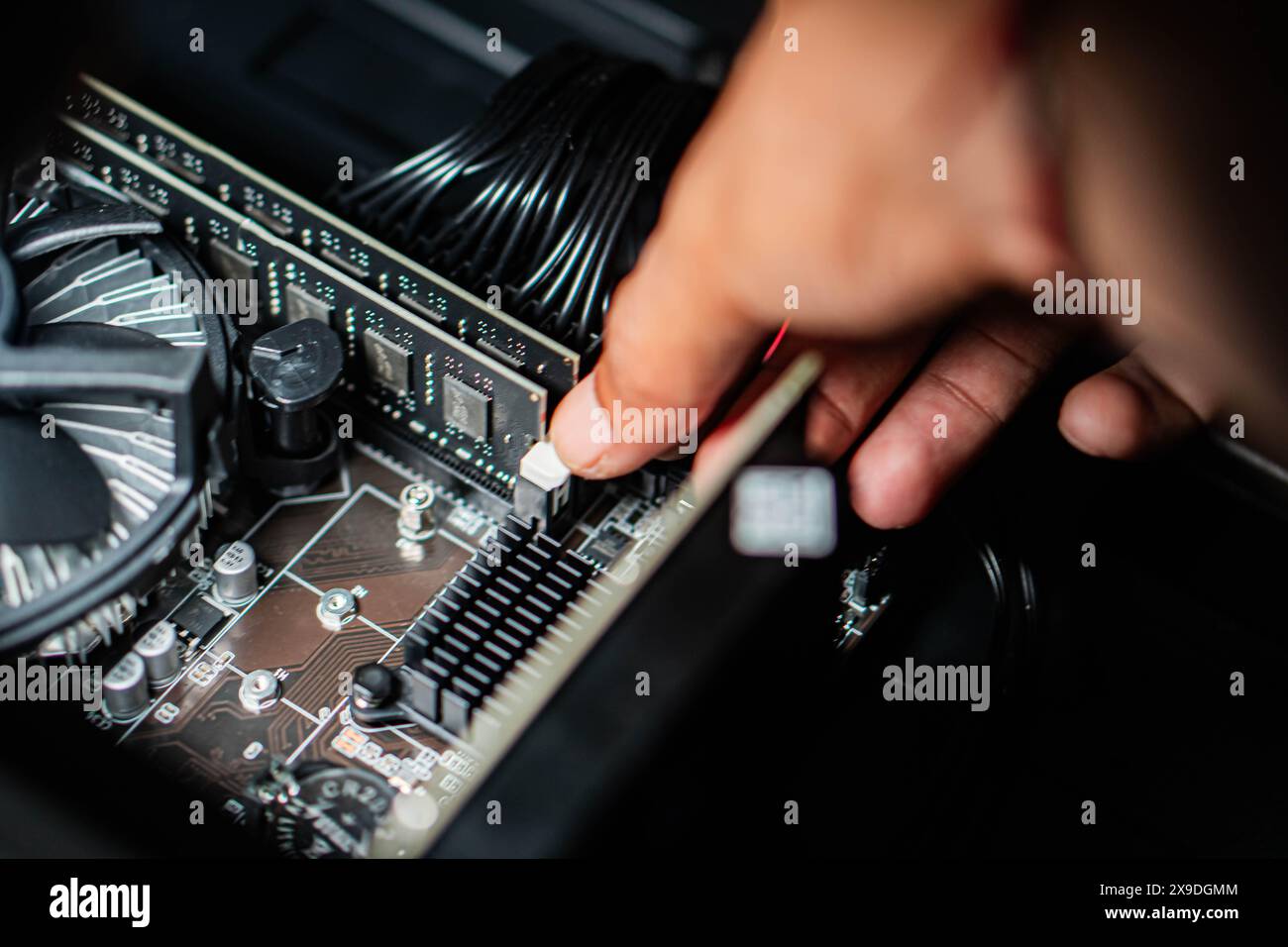 Close-up of a person installing or adjusting a component on a computer ...
