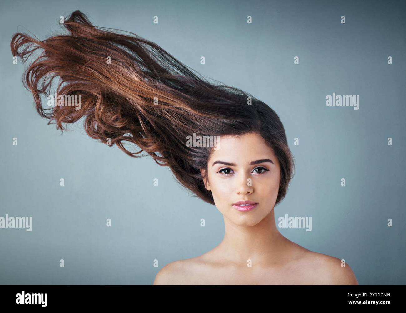 Woman, studio or portrait with wind in hair care and makeup, aesthetics ...