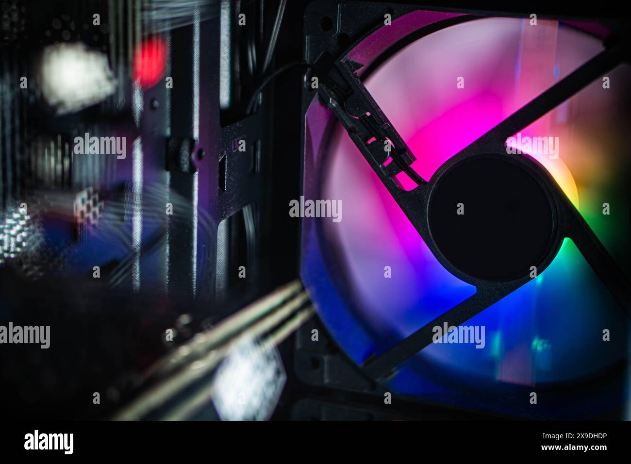 Close-up of a computer cooling fan with RGB lighting inside a PC case ...