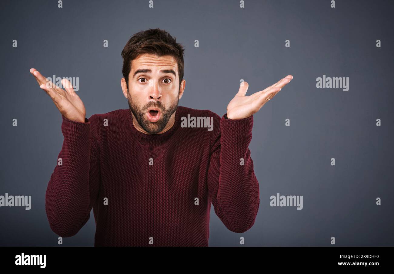 Studio, portrait and man with shock, confused and hands for question ...