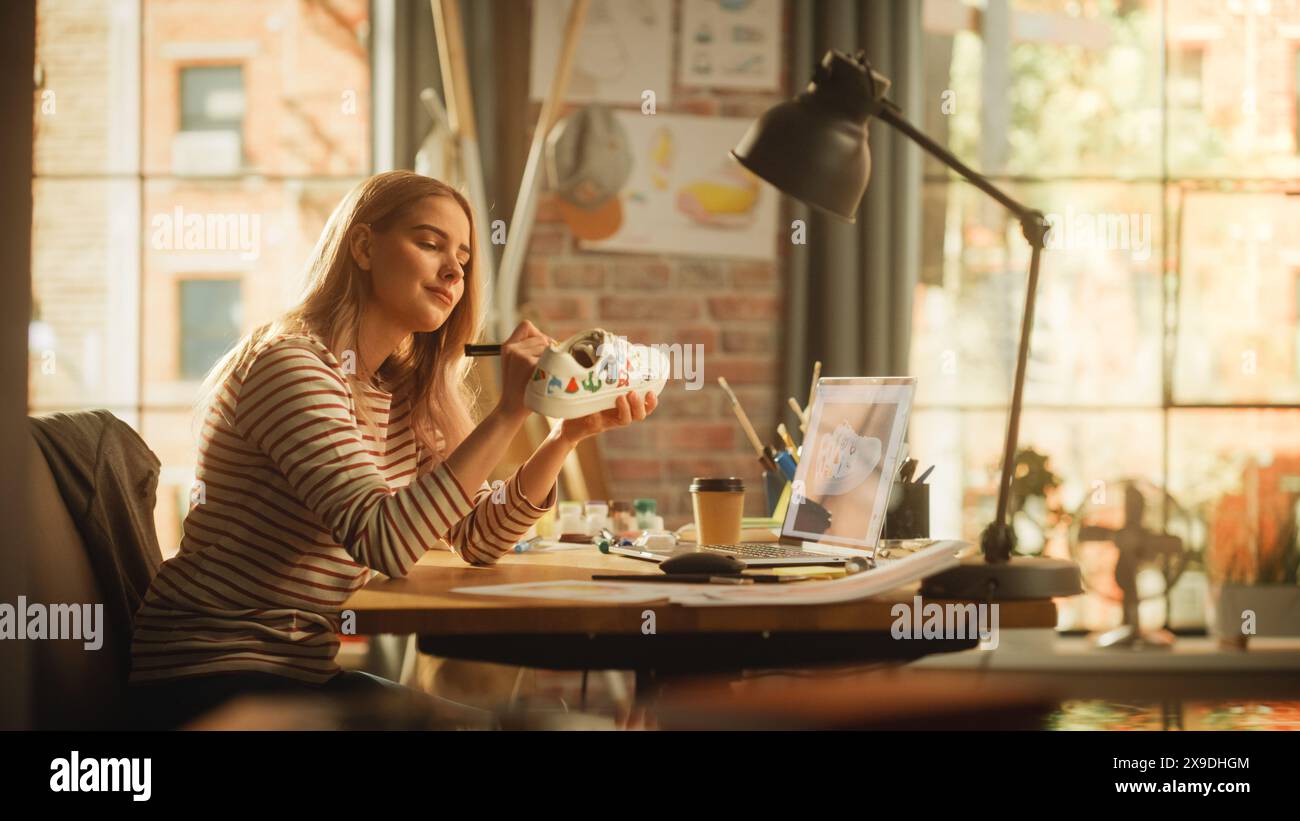 Female Creative Designer Working on Shoes and Uses Laptop Computer in ...