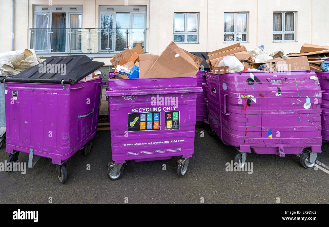 Filled recycle bins outside a residential building Stock Photo - Alamy