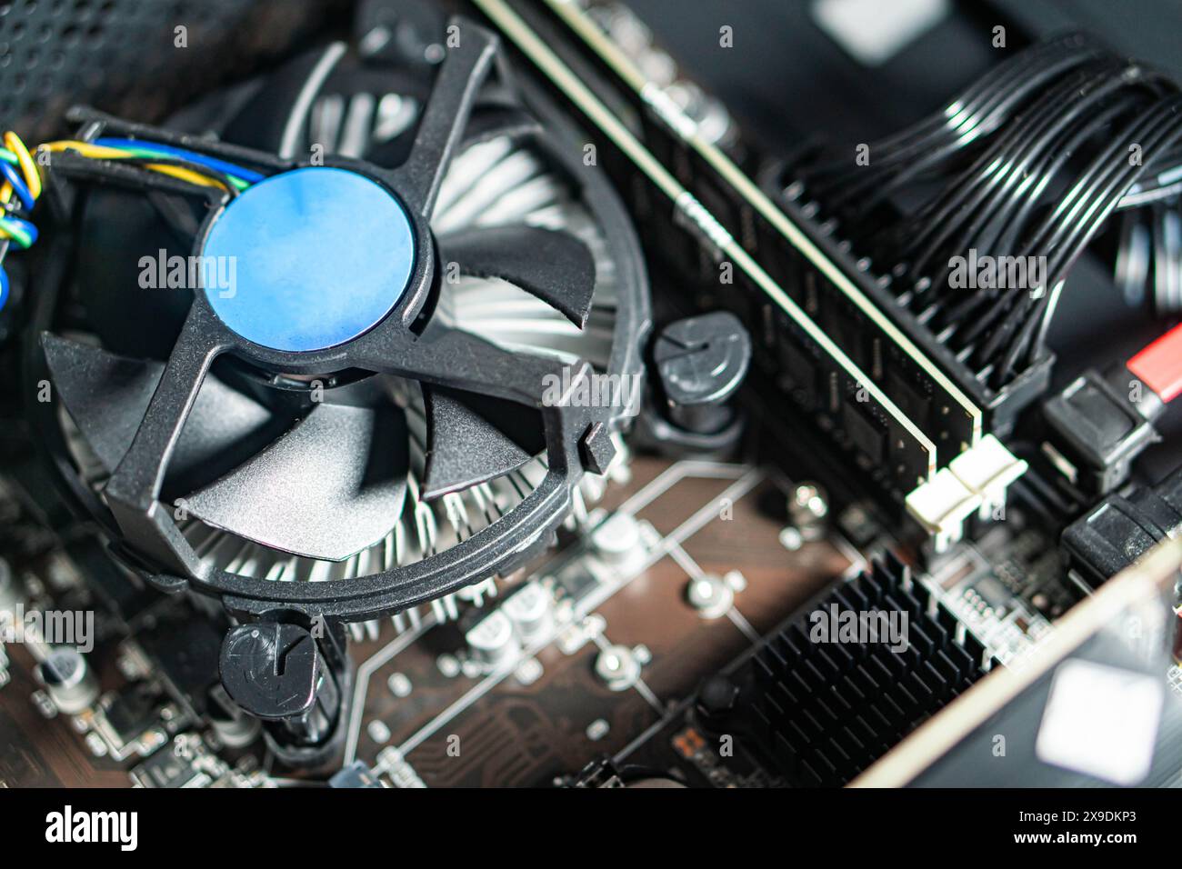 Close-up of a computer motherboard with a cooling fan and various ...