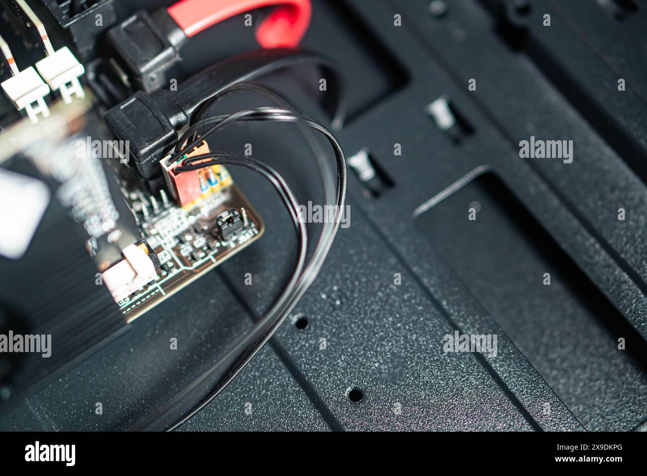 Close-up of computer motherboard with connected cables, focusing on the ...