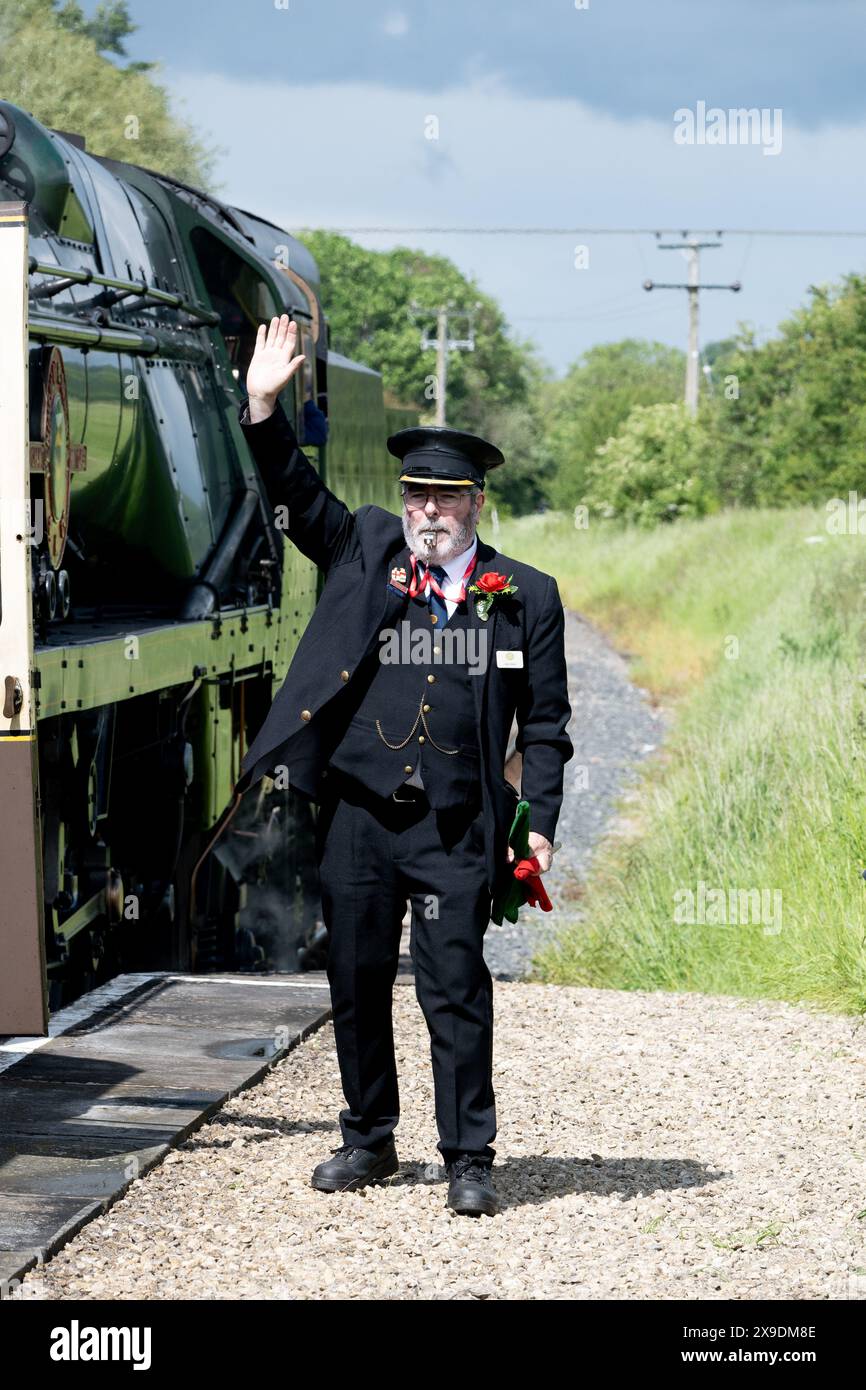 A guard on the Gloucestershire and Warwickshire Steam Railway ...