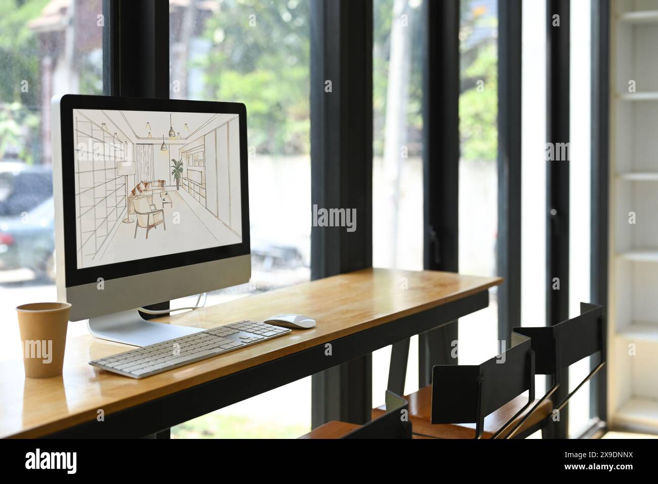 Desktop computer with interior sketch near window at creative office ...