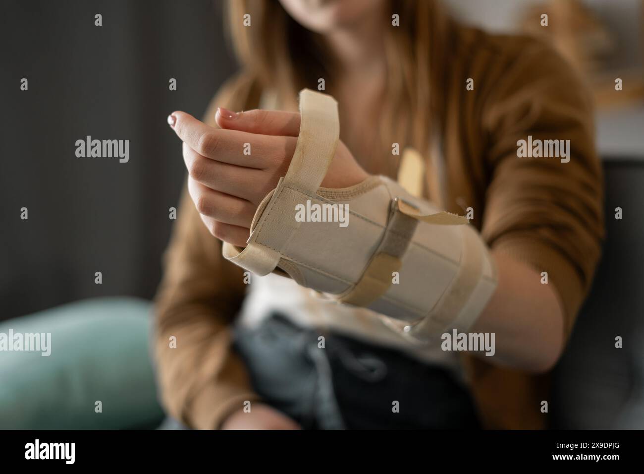 Broken wrist concept. Wrist to immobilize after injury. Woman uses arm ...