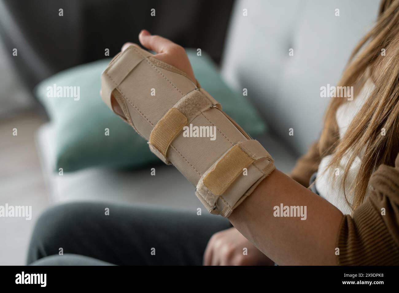 Hand injury. Broken wrist and arm with bandage or immobilizer. woman uses hand splints ...