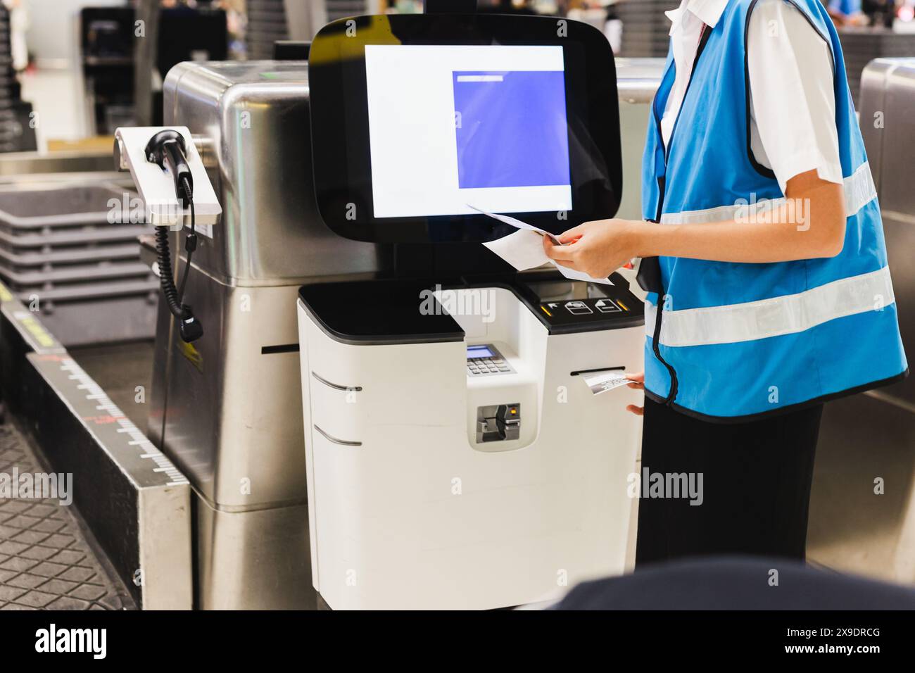 Female staff at Airport International Terminal self-service check-in ...