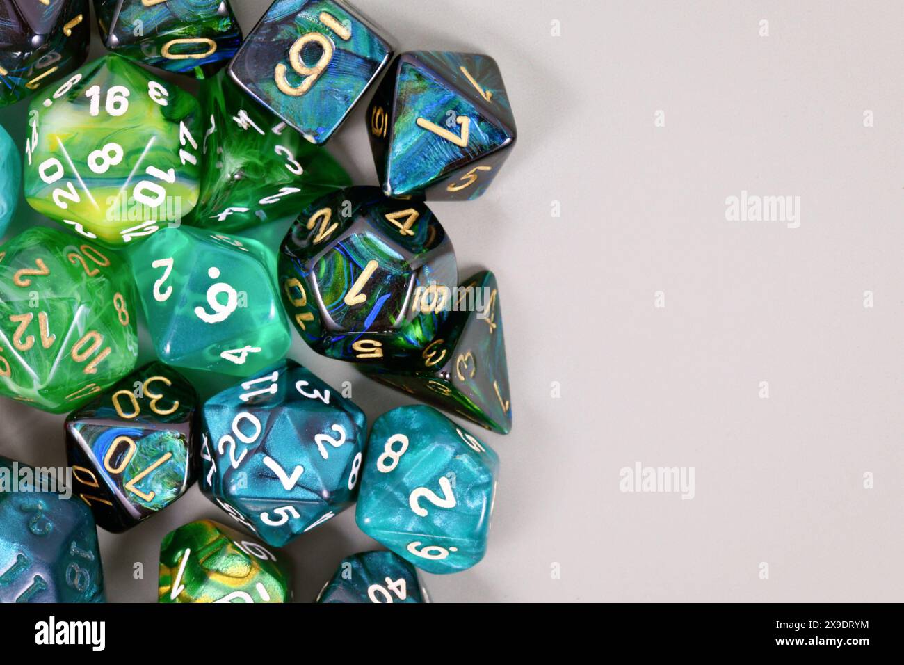 Blue and green roleplaying game RPG dice on side of gray background ...