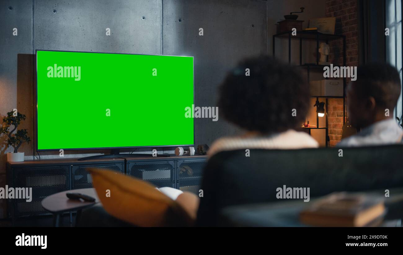 African American Couple Watching TV with Green Screen Mockup Display ...