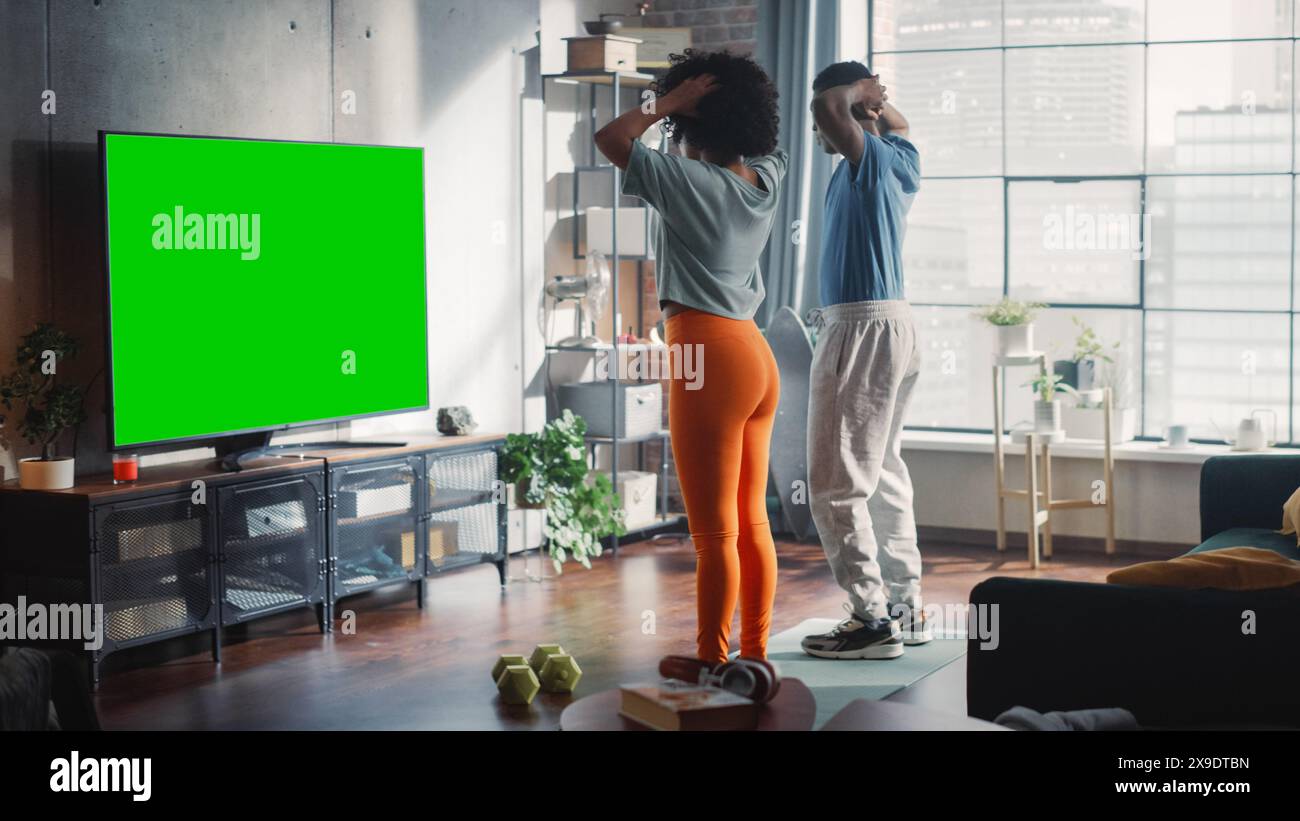 Athletic Black Couple Training Together, Jumping Infront of Green ...