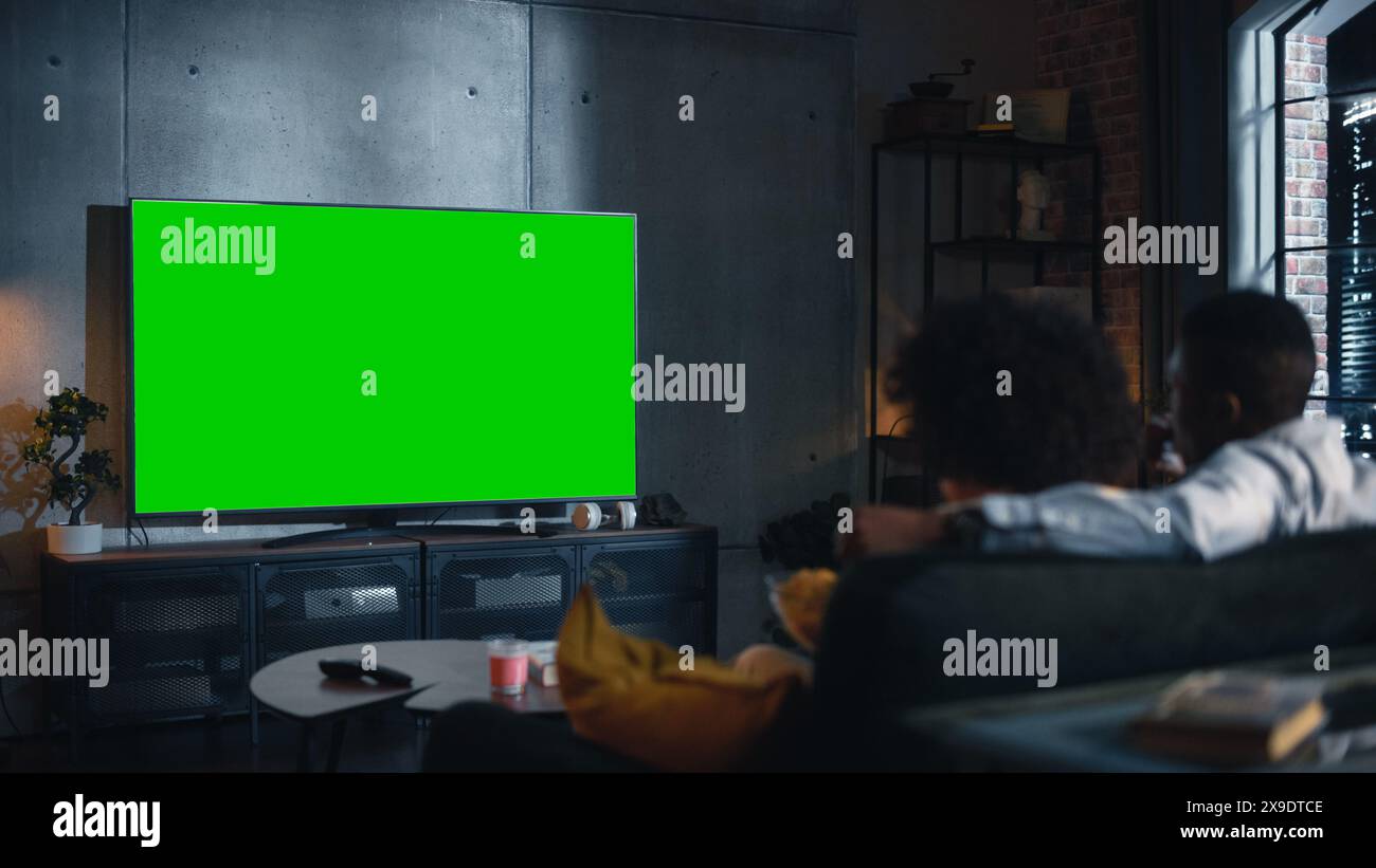 African American Couple Watching TV with Green Screen Mockup Display ...