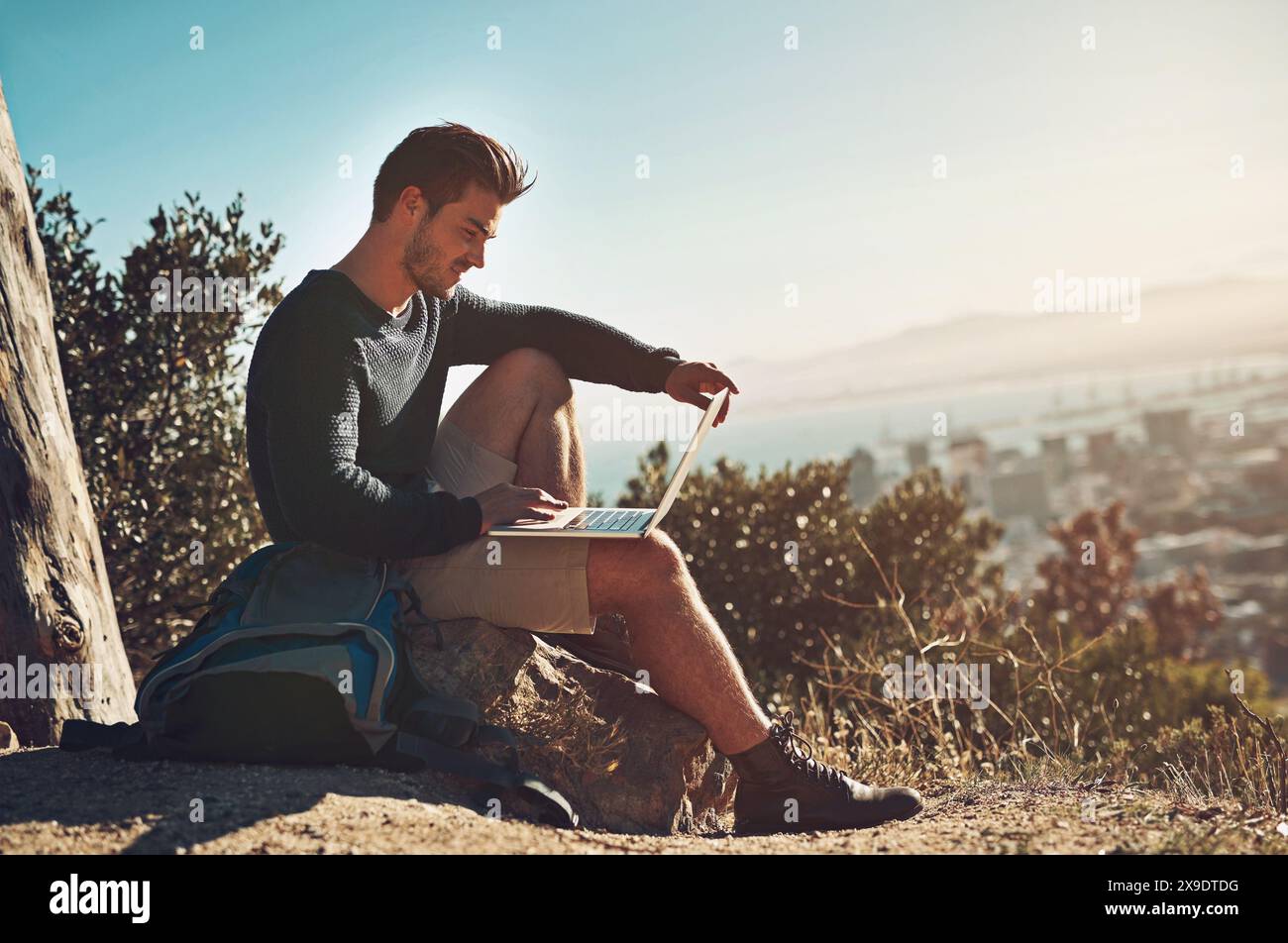 Happy, man and hiker with laptop outdoor for remote work, connection ...