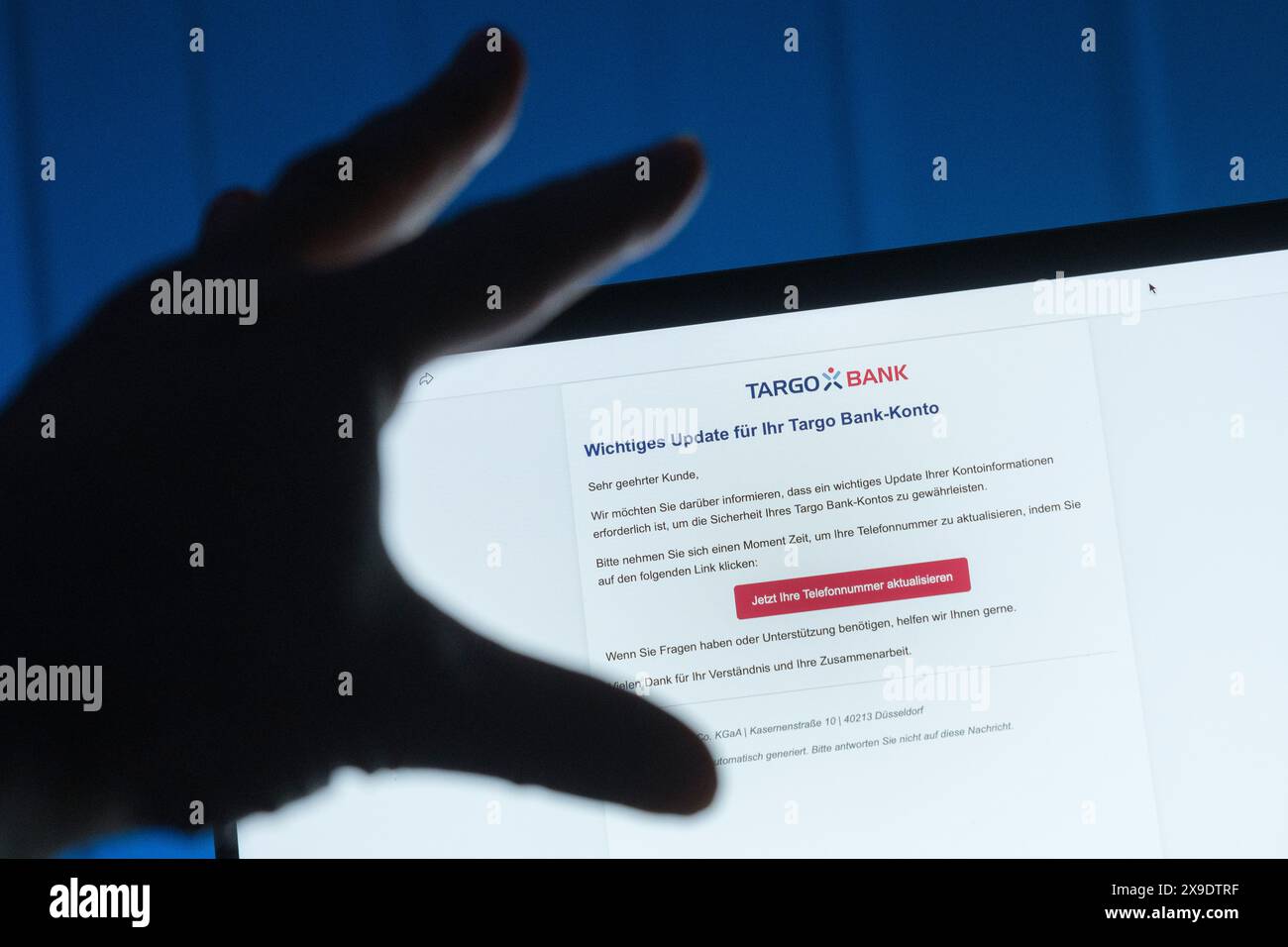 Fraudulent phishing email on a laptop requesting an important update ...