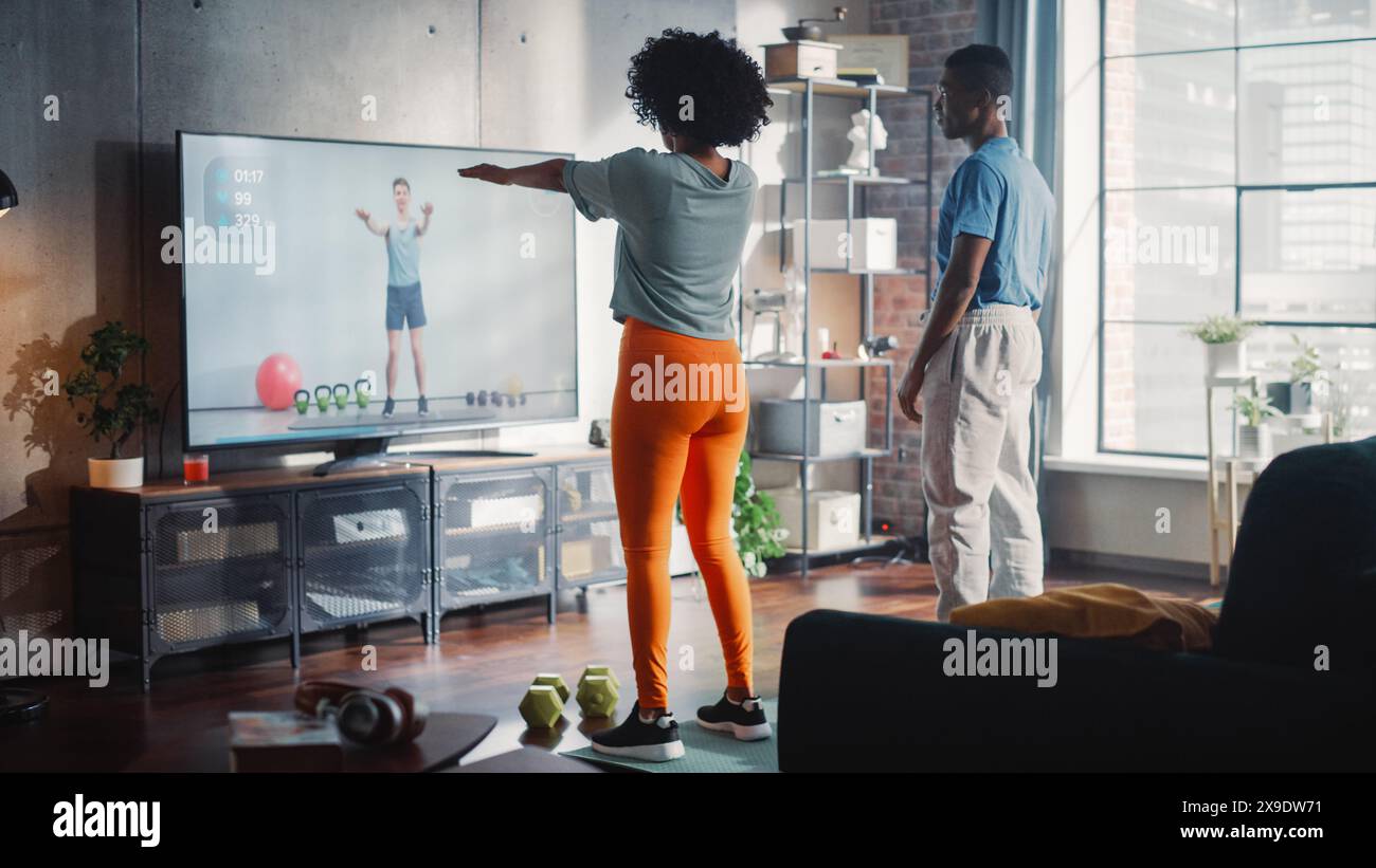 Black Strong Couple Training Together at Home And Watching Tutorial on ...