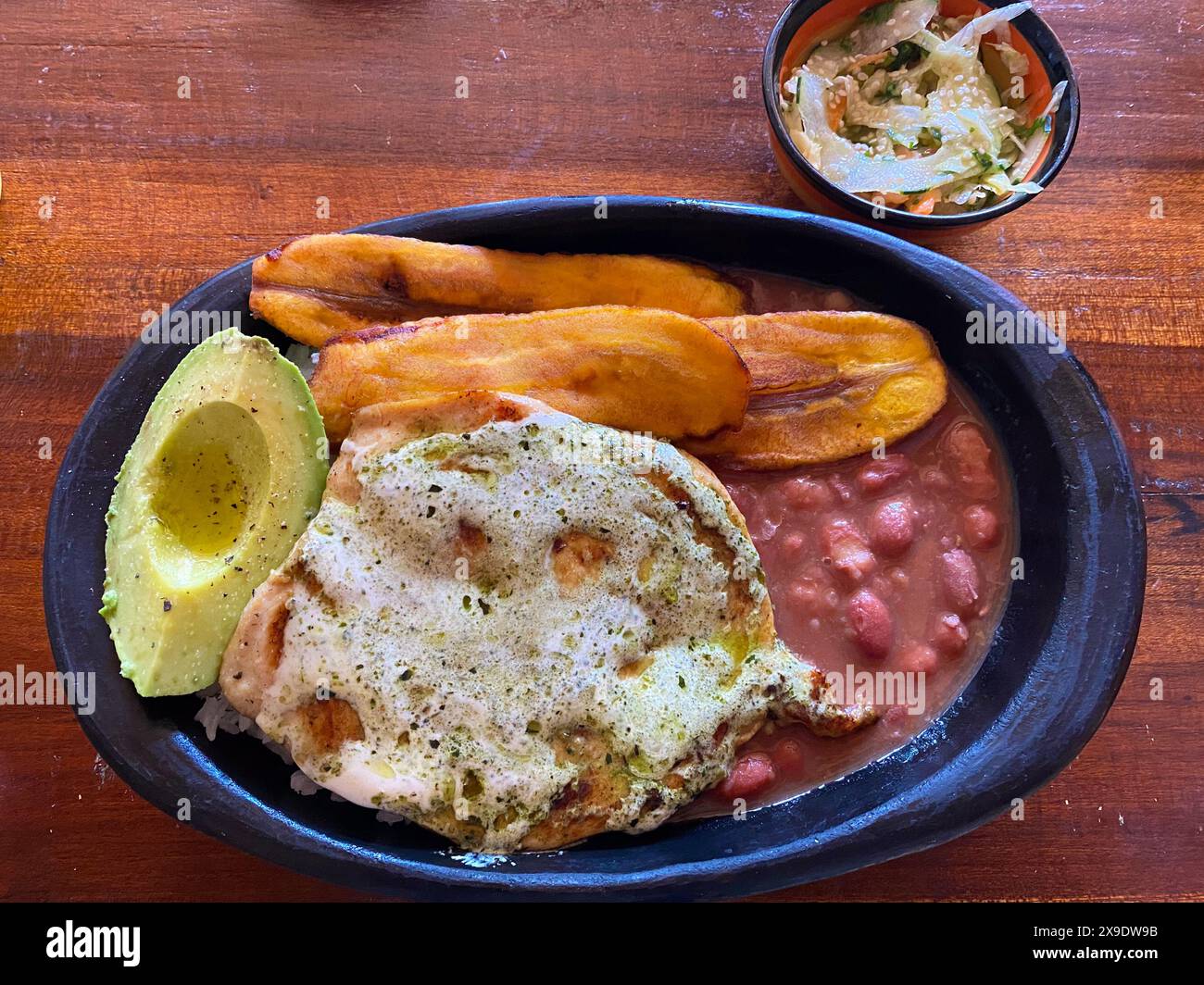 Overhead view of a traditional Latin American dish featuring fried ...