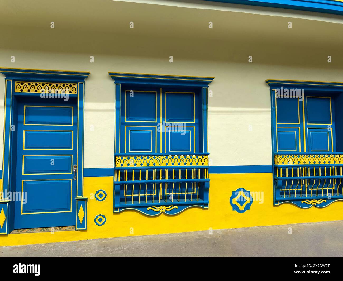 A brightly colored colonial building with intricate blue and yellow ...