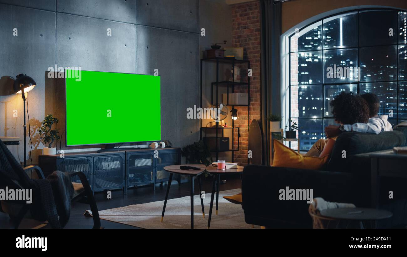 Black Couple In Love Sitting on a Couch, Watching Green Screen Chroma ...