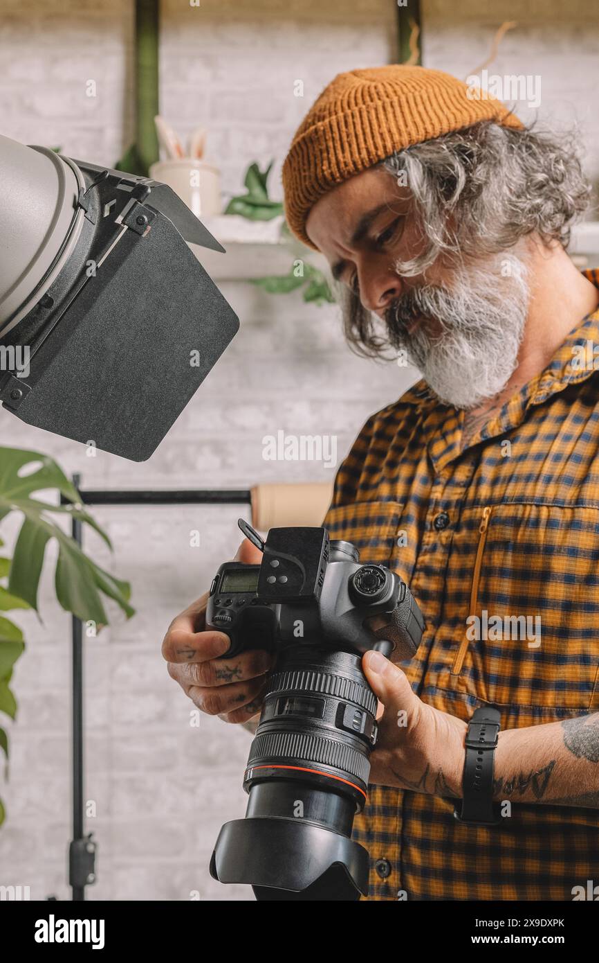 Photographer in the studio reviewing the shots Stock Photo - Alamy